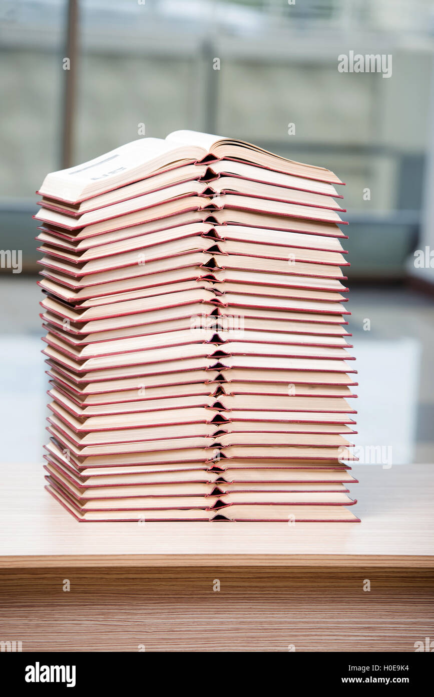 Stack of books arranged the office desk Stock Photo - Alamy