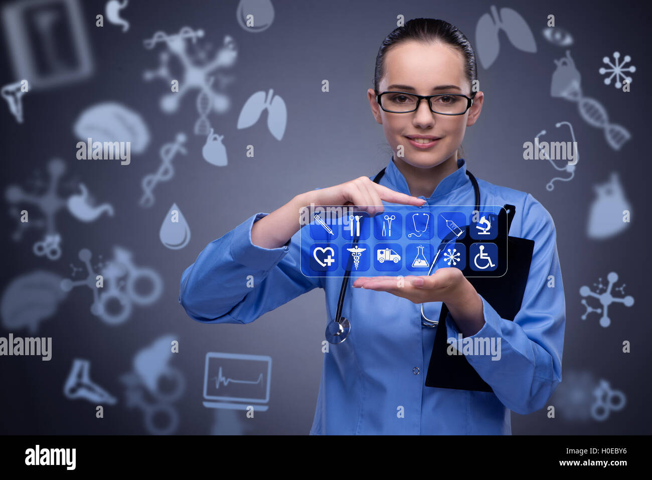Woman doctor pressing buttons with various medical icons Stock Photo ...