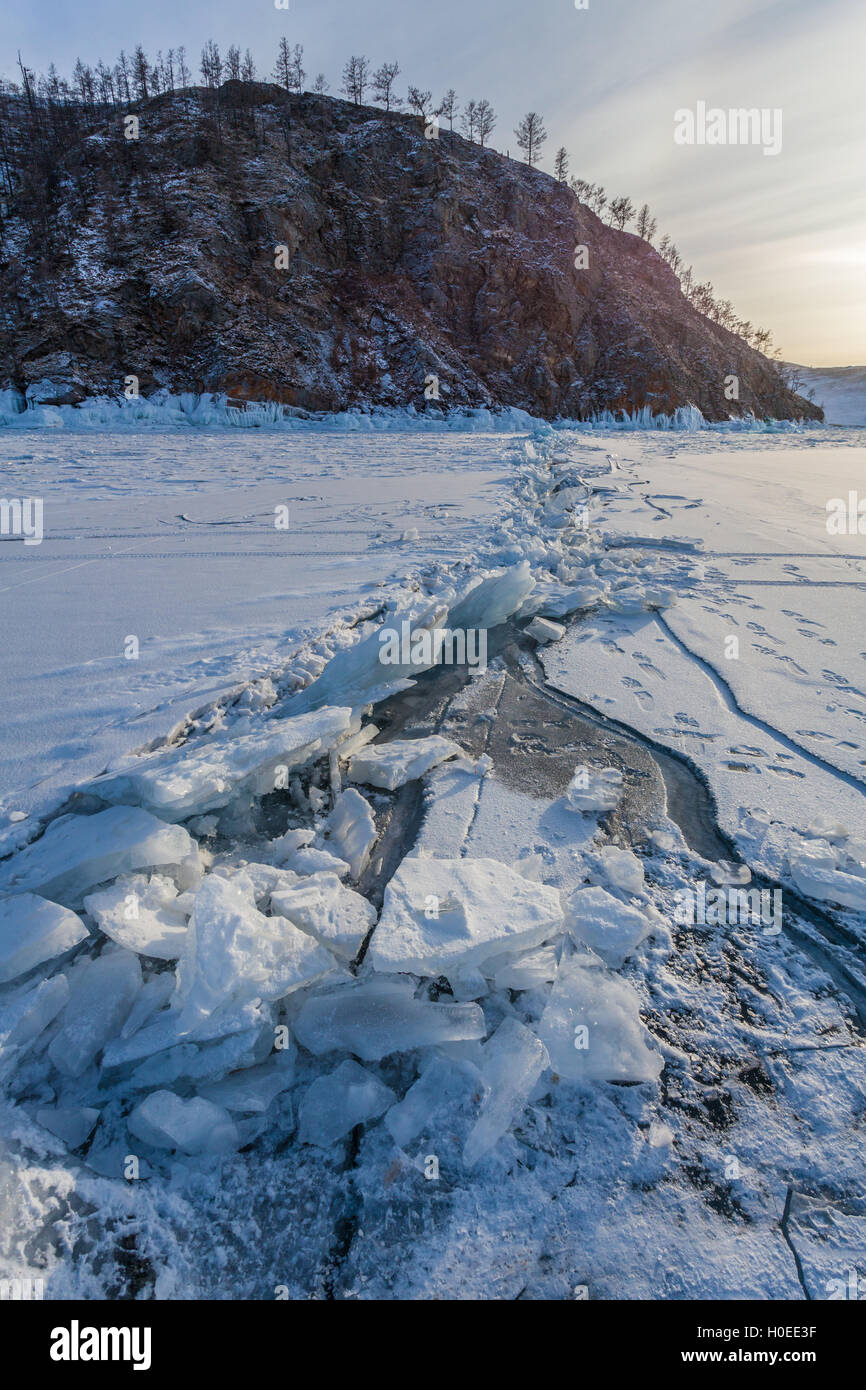 Perspective ice crack to rock with trees. The Baikal lake Stock Photo ...