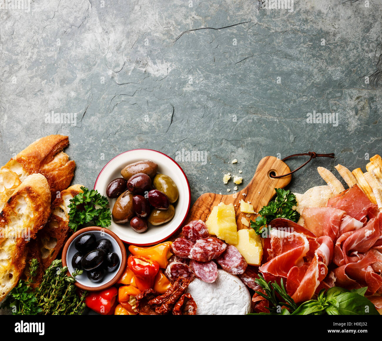 Italian food ingredients background with ham, salami, parmesan, olives ...