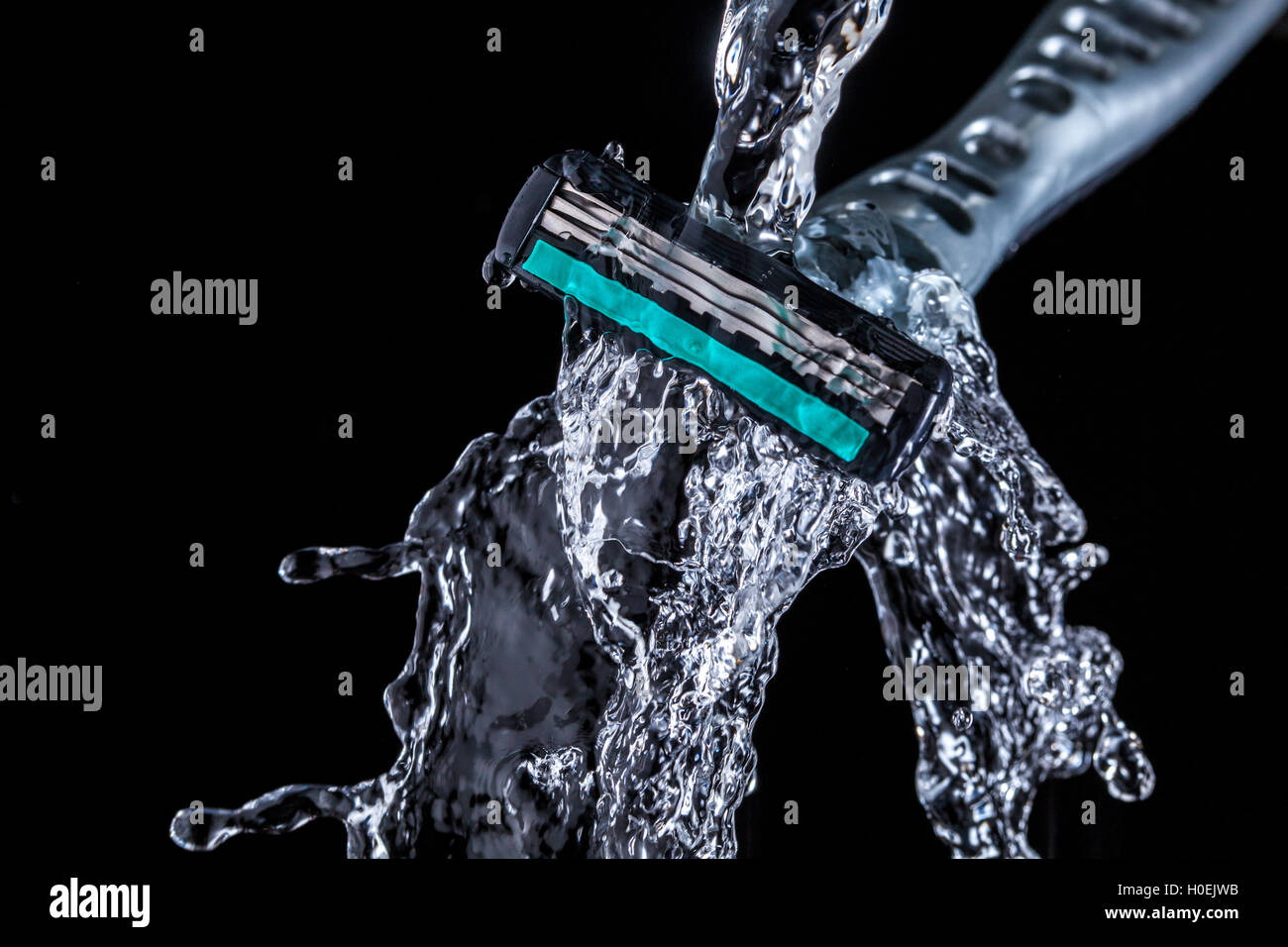 Disposable Razor with water splash Stock Photo - Alamy