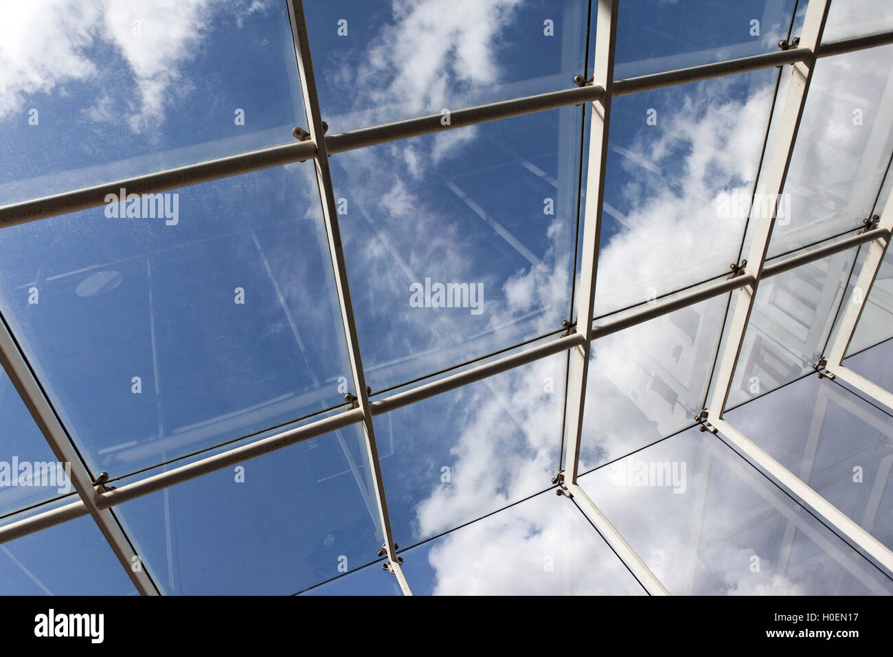 Close up of a glass roof and blue sky Stock Photo - Alamy