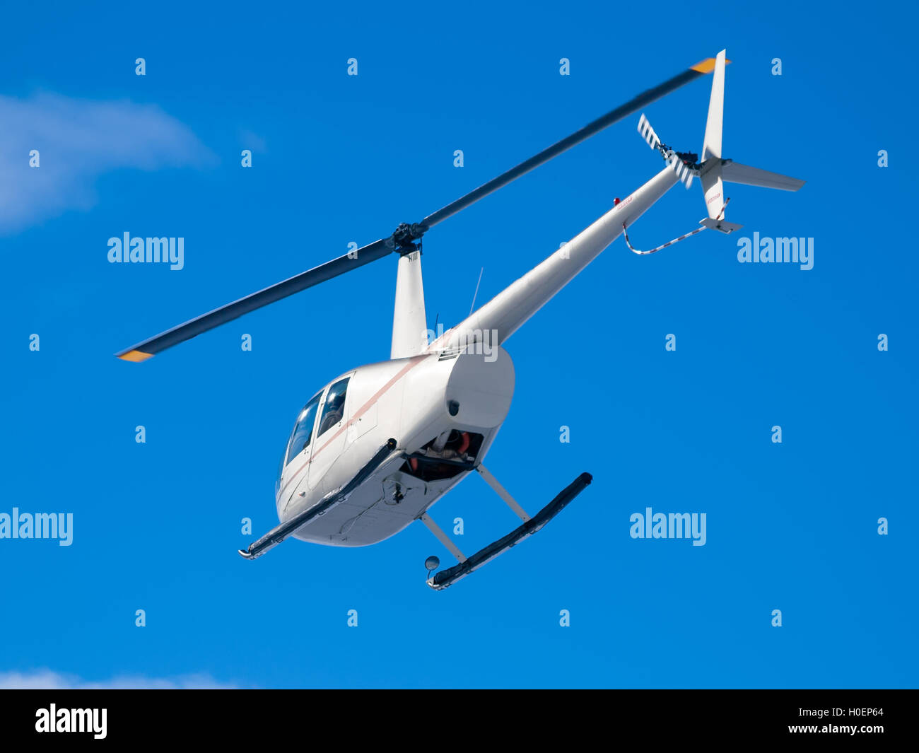 Helicopter flying in blue sky view from under and behind Stock Photo ...