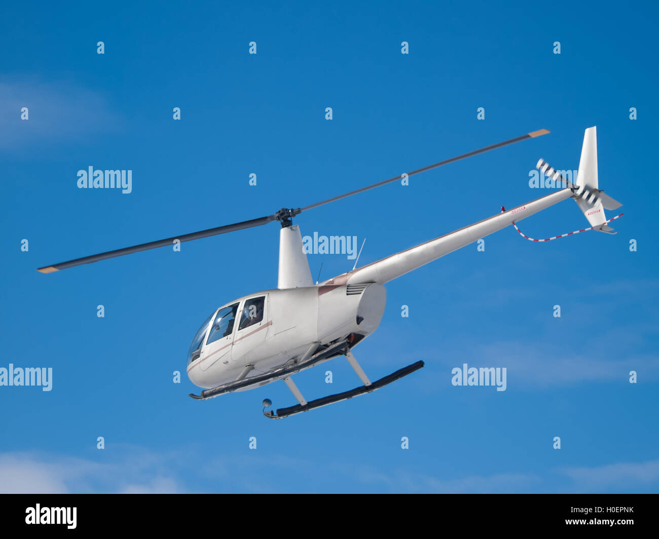 Helicopter flying in the blue sky Stock Photo - Alamy