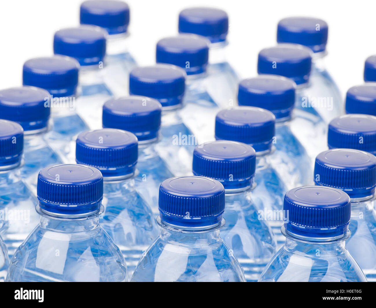 Rows of water bottles isolated on white background Stock Photo - Alamy