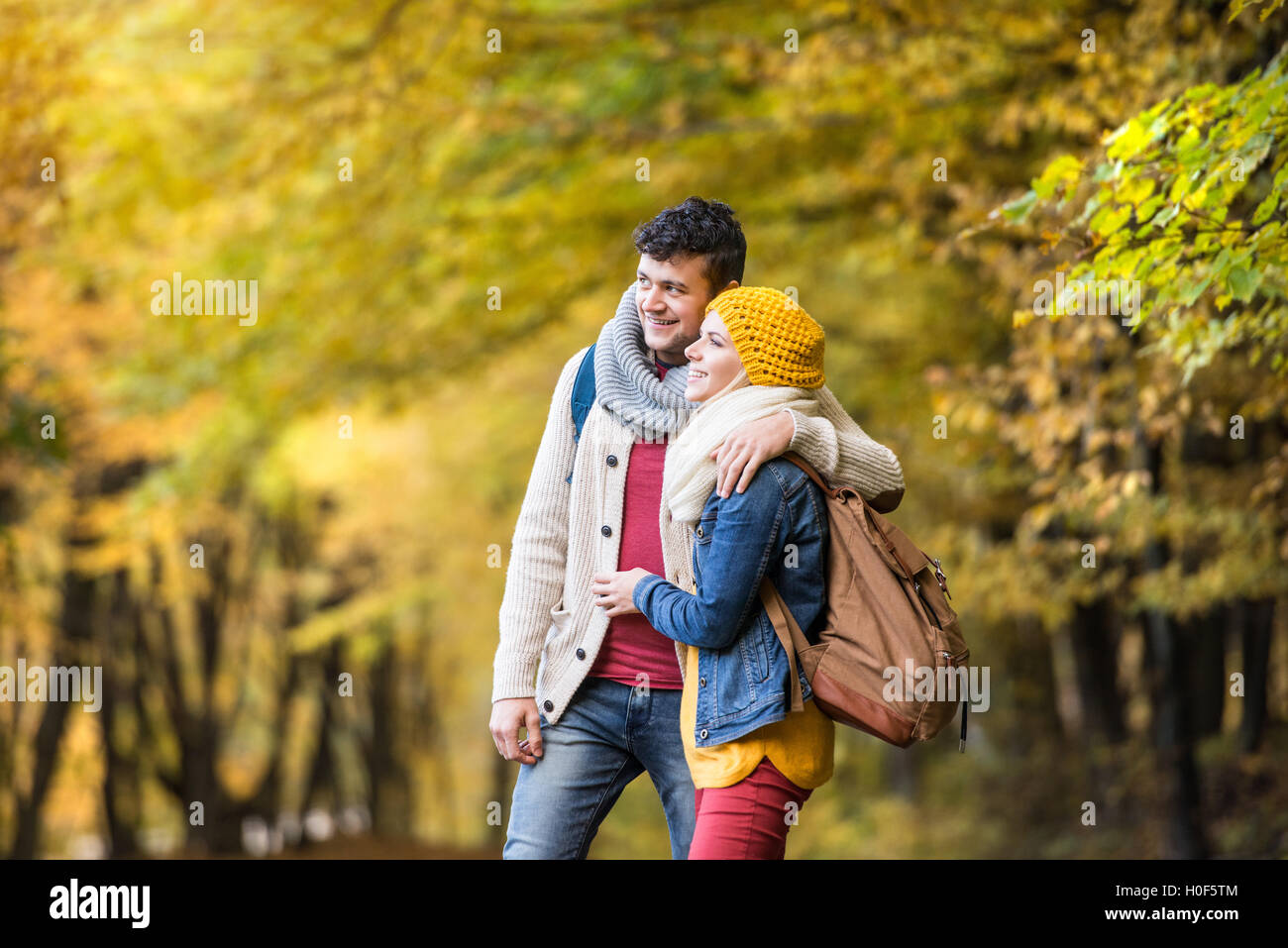 Beautiful couple on a walk in autumn forest Stock Photo - Alamy