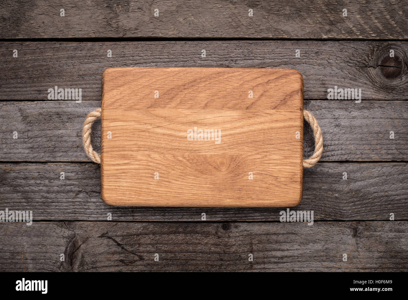 Chopping board on rustic table Stock Photo - Alamy