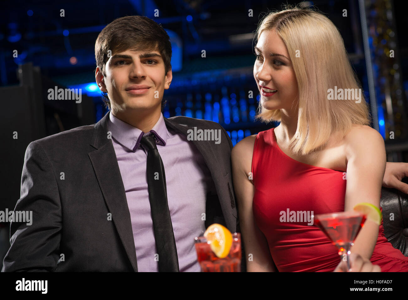Young couple talking in a nightclub Stock Photo - Alamy