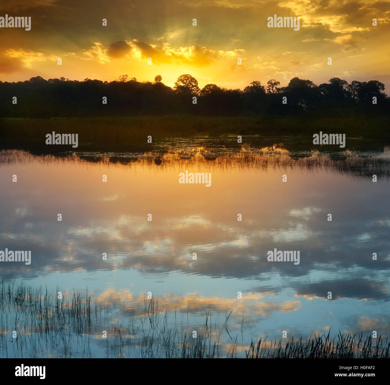 Sunset Over A Lake Stock Photo - Alamy