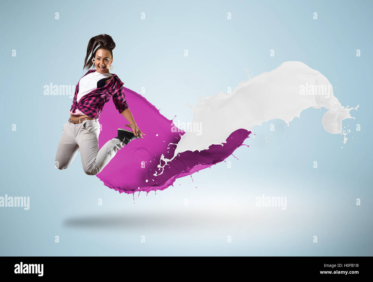 young female dancer jumping with splash of paint Stock Photo - Alamy