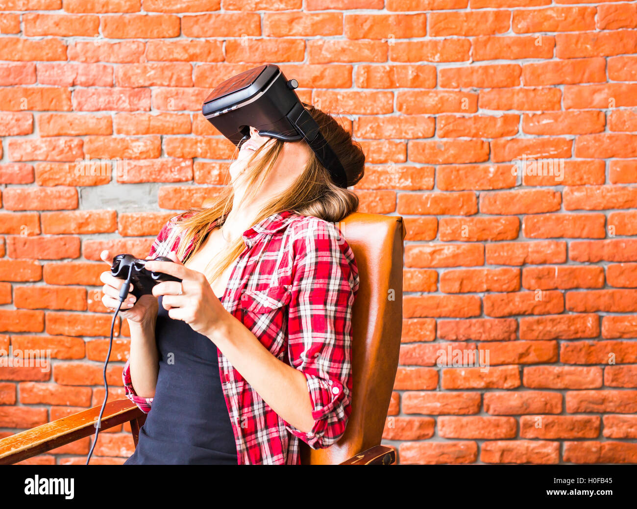 Happy woman playing games with the virtual reality headset Stock Photo ...