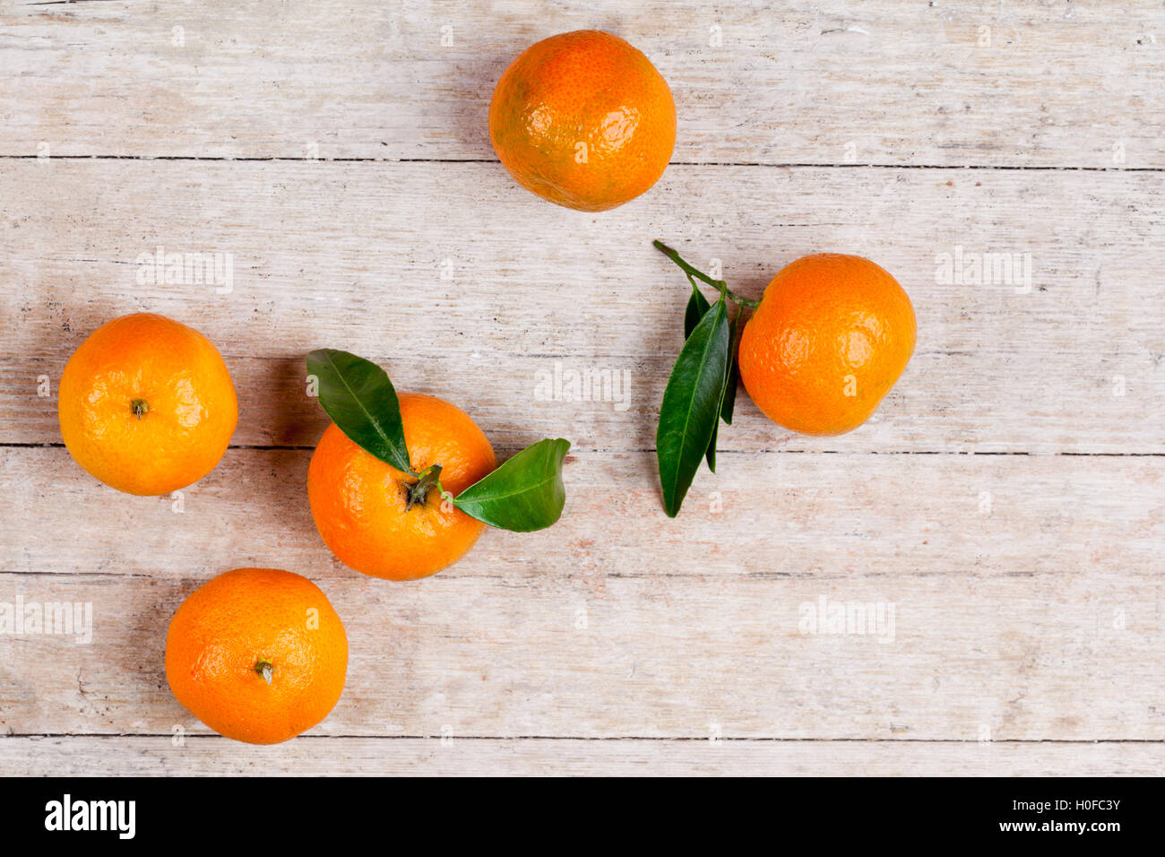 five tangerines with leaves Stock Photo - Alamy