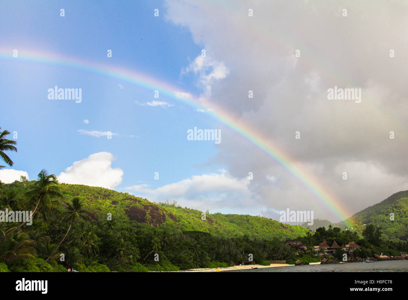 Rainbow over tropical island and white beach at Seychelles Stock Photo ...
