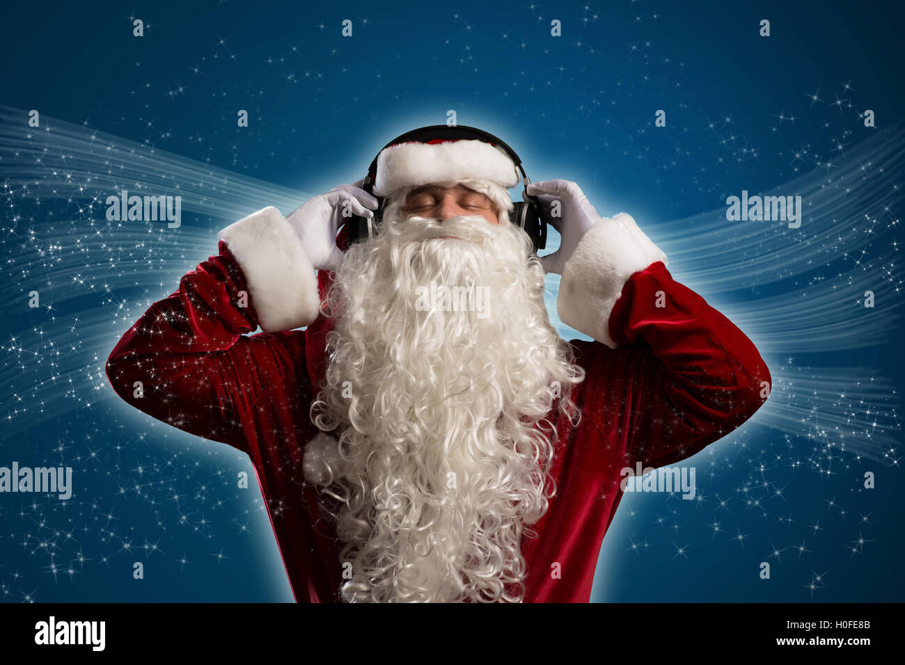 Santa Claus is listening to music Stock Photo - Alamy
