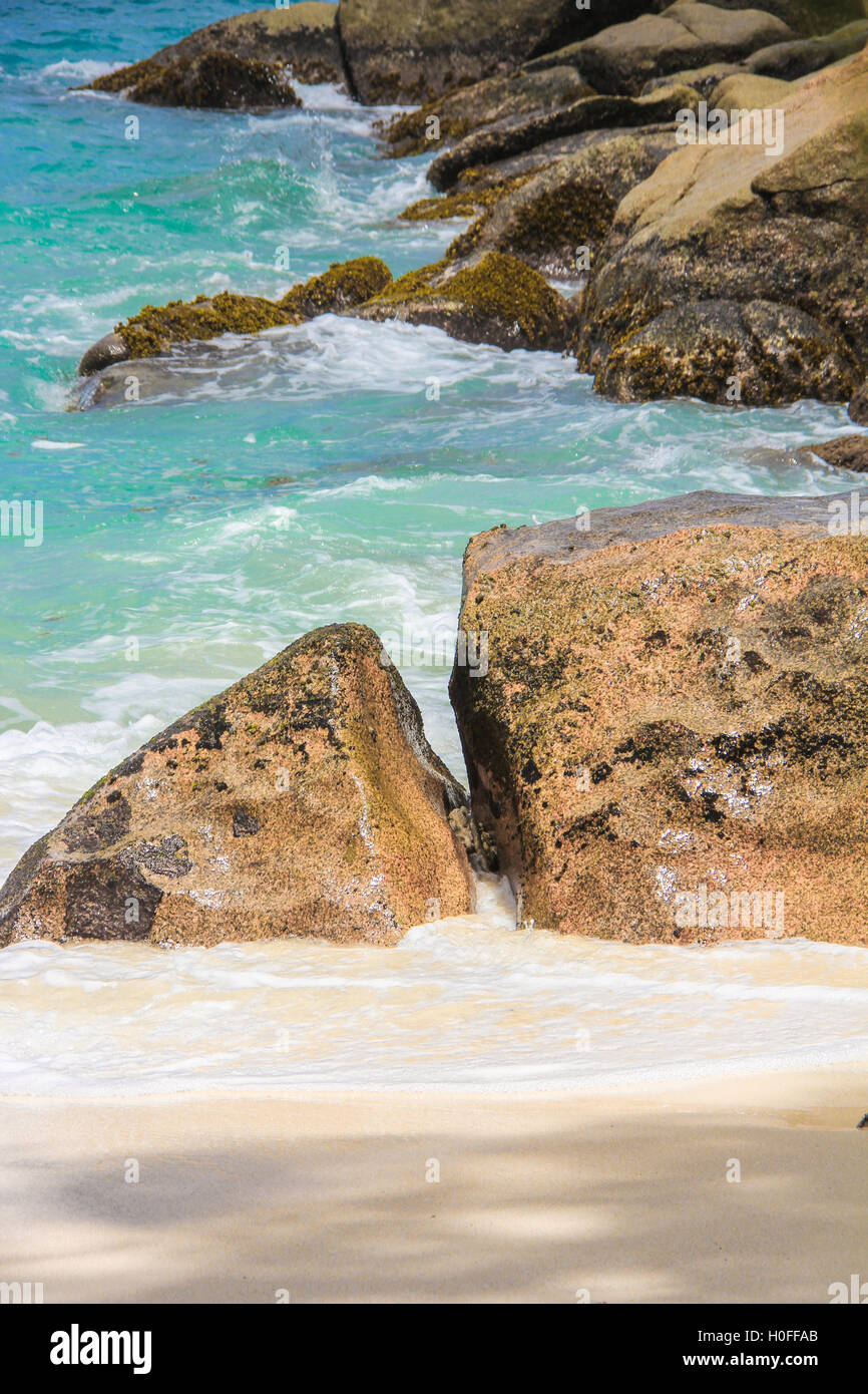 Large smooth stones with turquoise water on the paradise island of ...