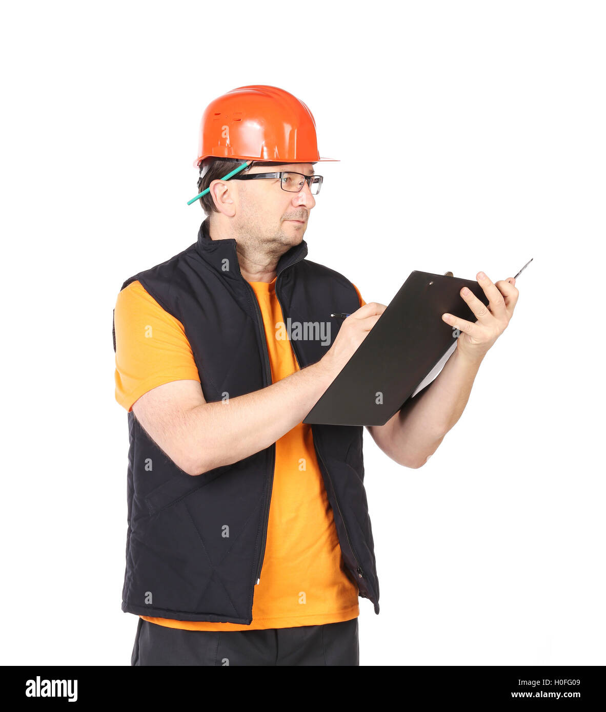 Worker writing in folder Stock Photo - Alamy