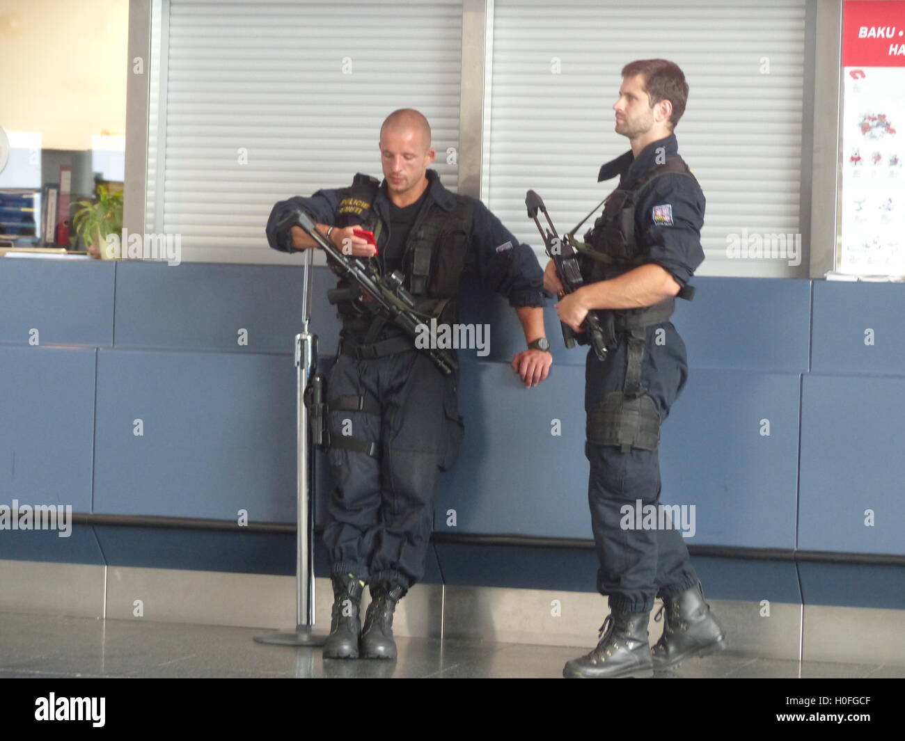 Police with machine guns patrol Vaclav Havel International Airport ...