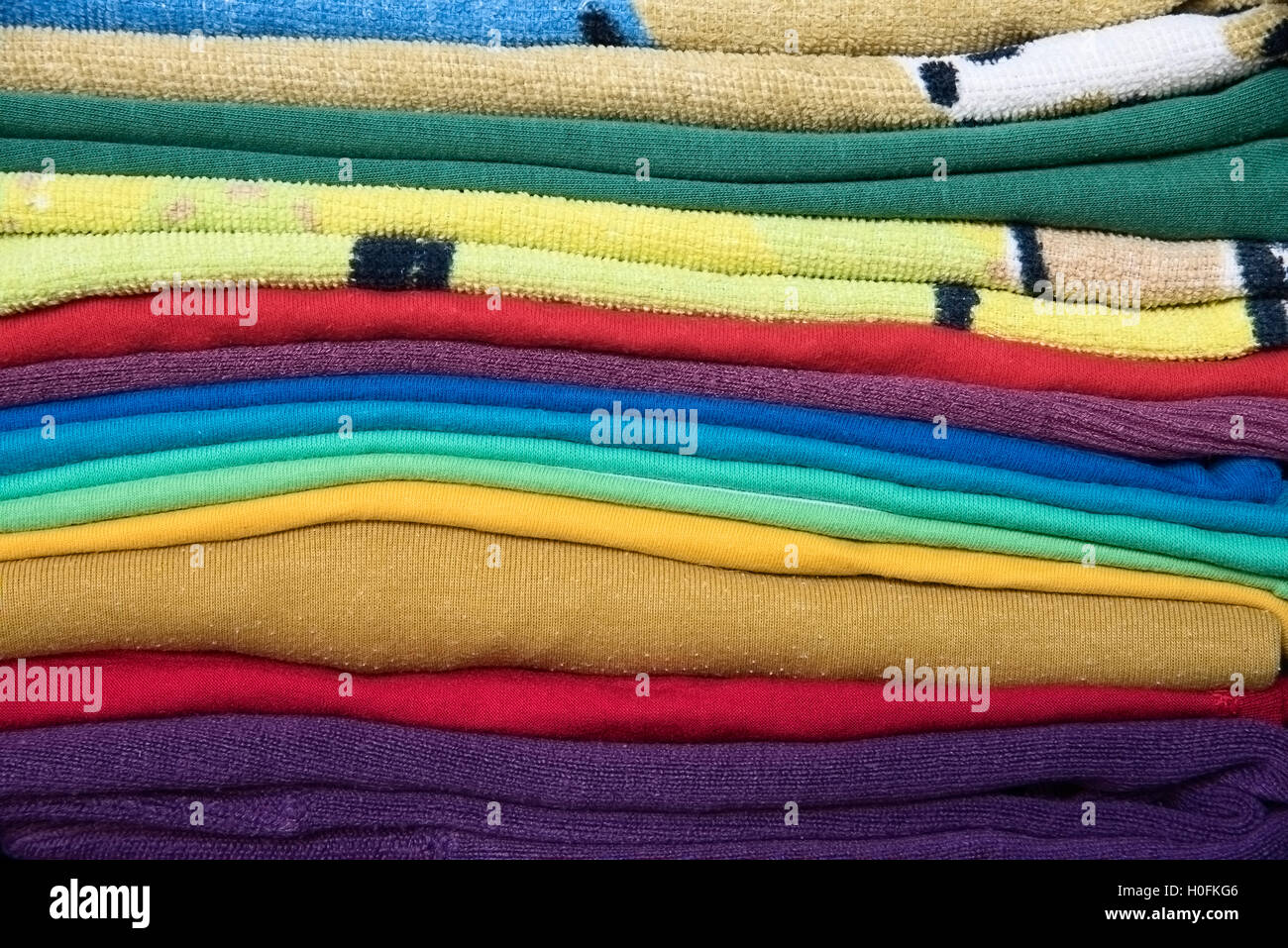 close up of a colorful stack of folded clothes texture background Stock ...