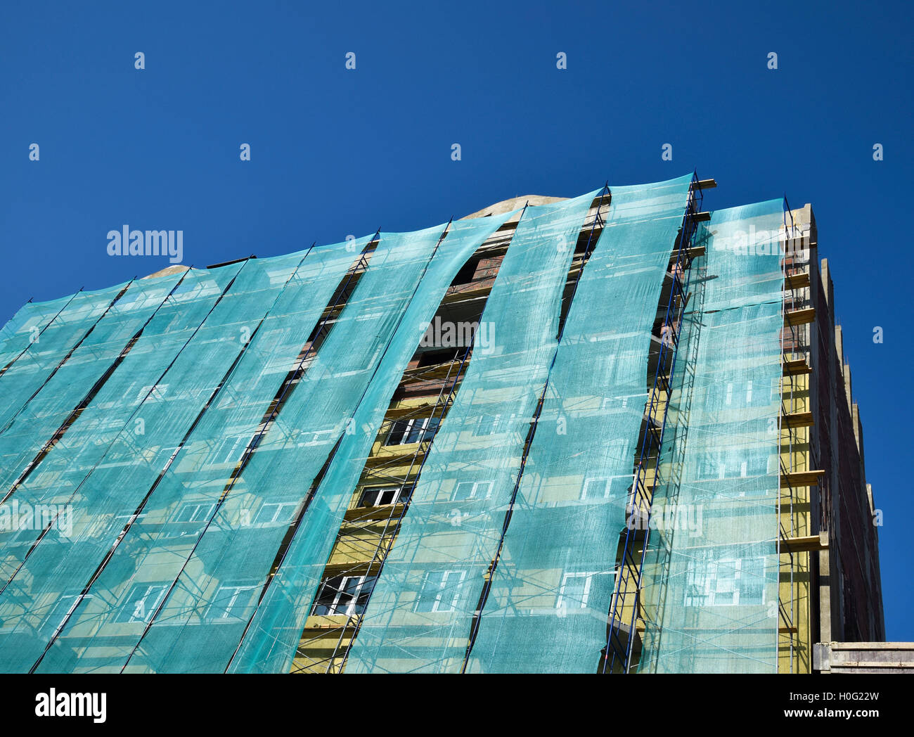 Safety net in the newly built high-rise building. Green grid on ...