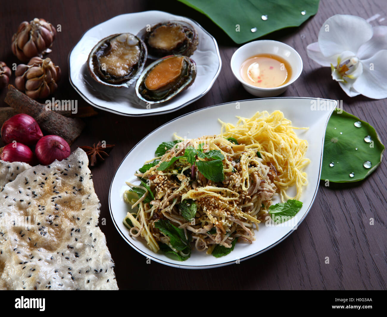 Abalone with special sliced pork and herbs salad with rice cracker on ...