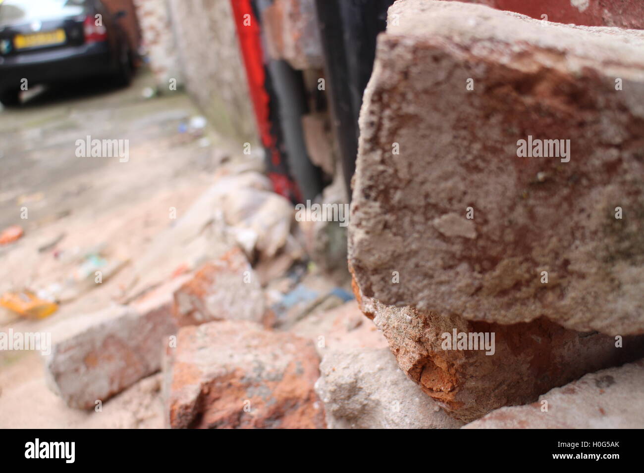 Photo of decrepit and run down area in Blackpool. Brick in foreground ...