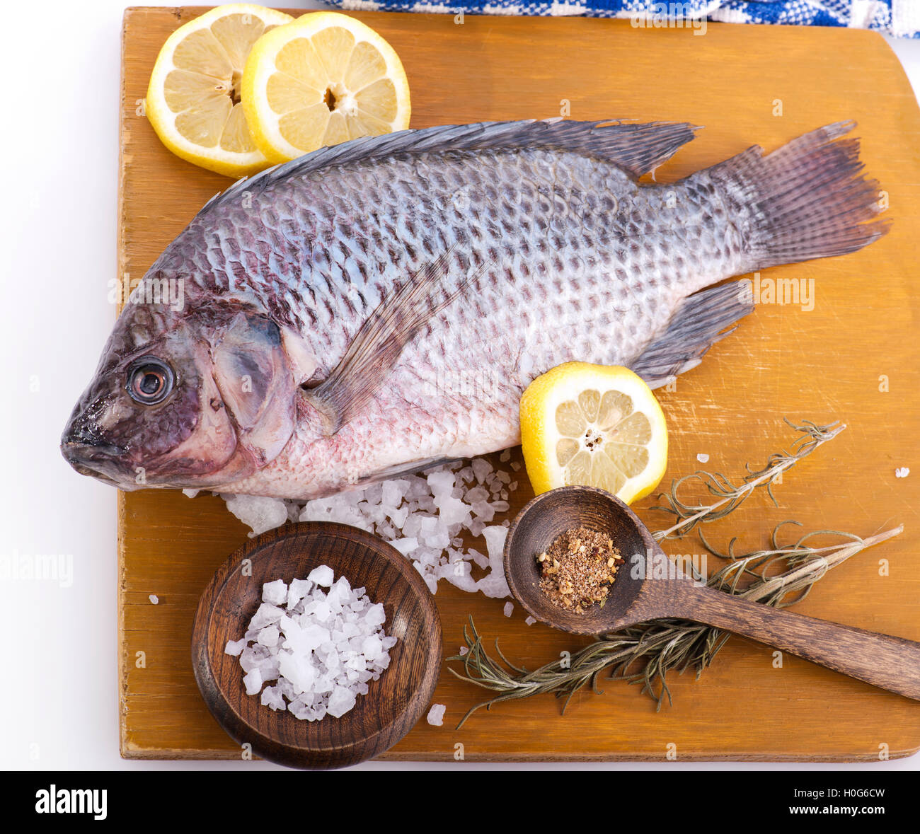 Raw Whole Fish on a cutting board Stock Photo - Alamy