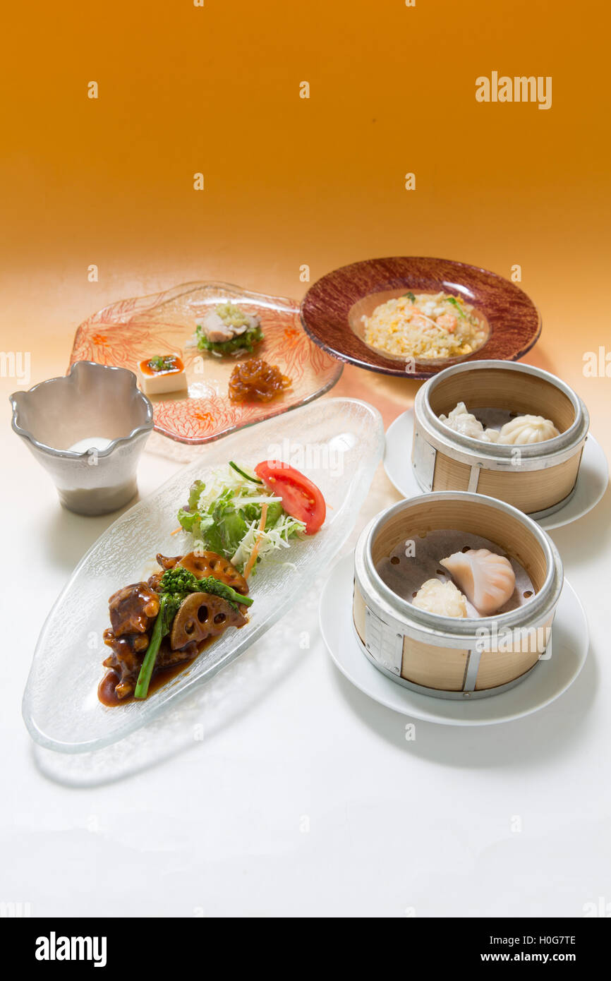 Courses of japanese meal with dumplings, sauteed meat and rice on white ...