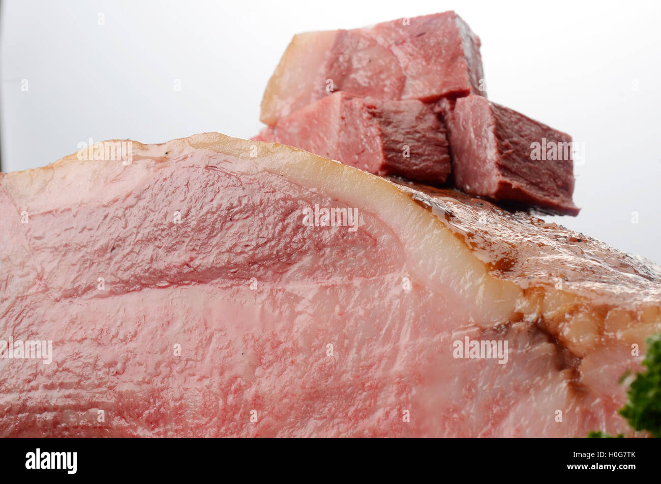 Roasted beef meat on white background in restaurant Stock Photo - Alamy