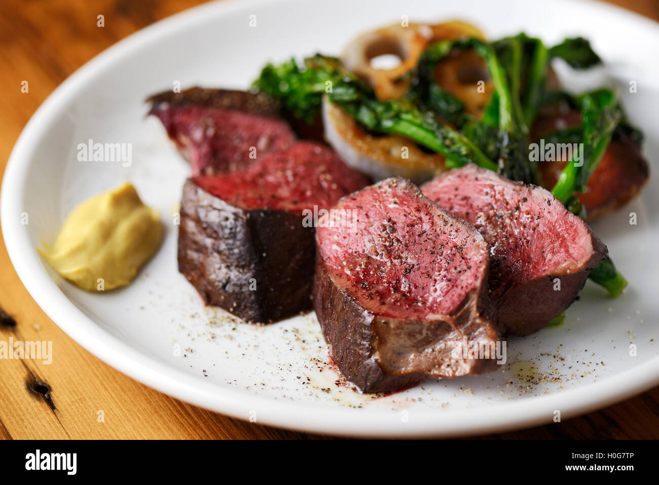Roasted cubed cow heart on white plate with vegetables Stock Photo - Alamy