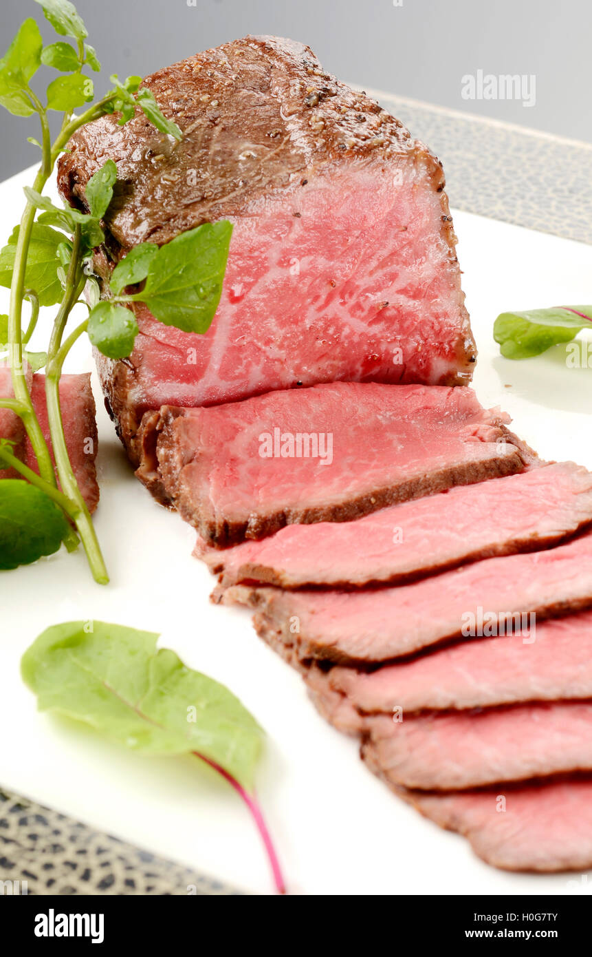 Roast beef of charm and character on white plate Stock Photo - Alamy