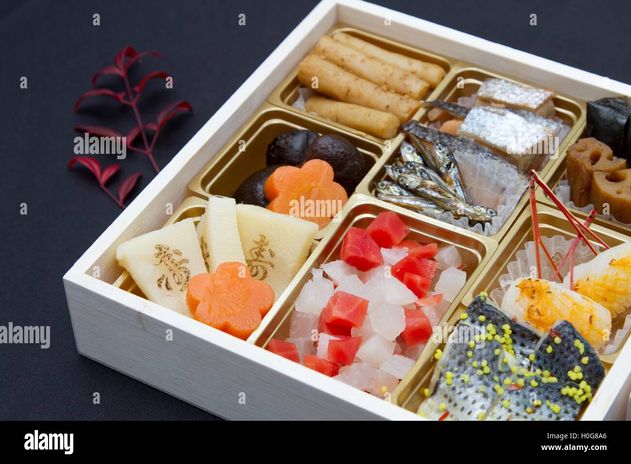 Bento meal of fish, carrot, mushroom, squid, and fermented vegetables ...