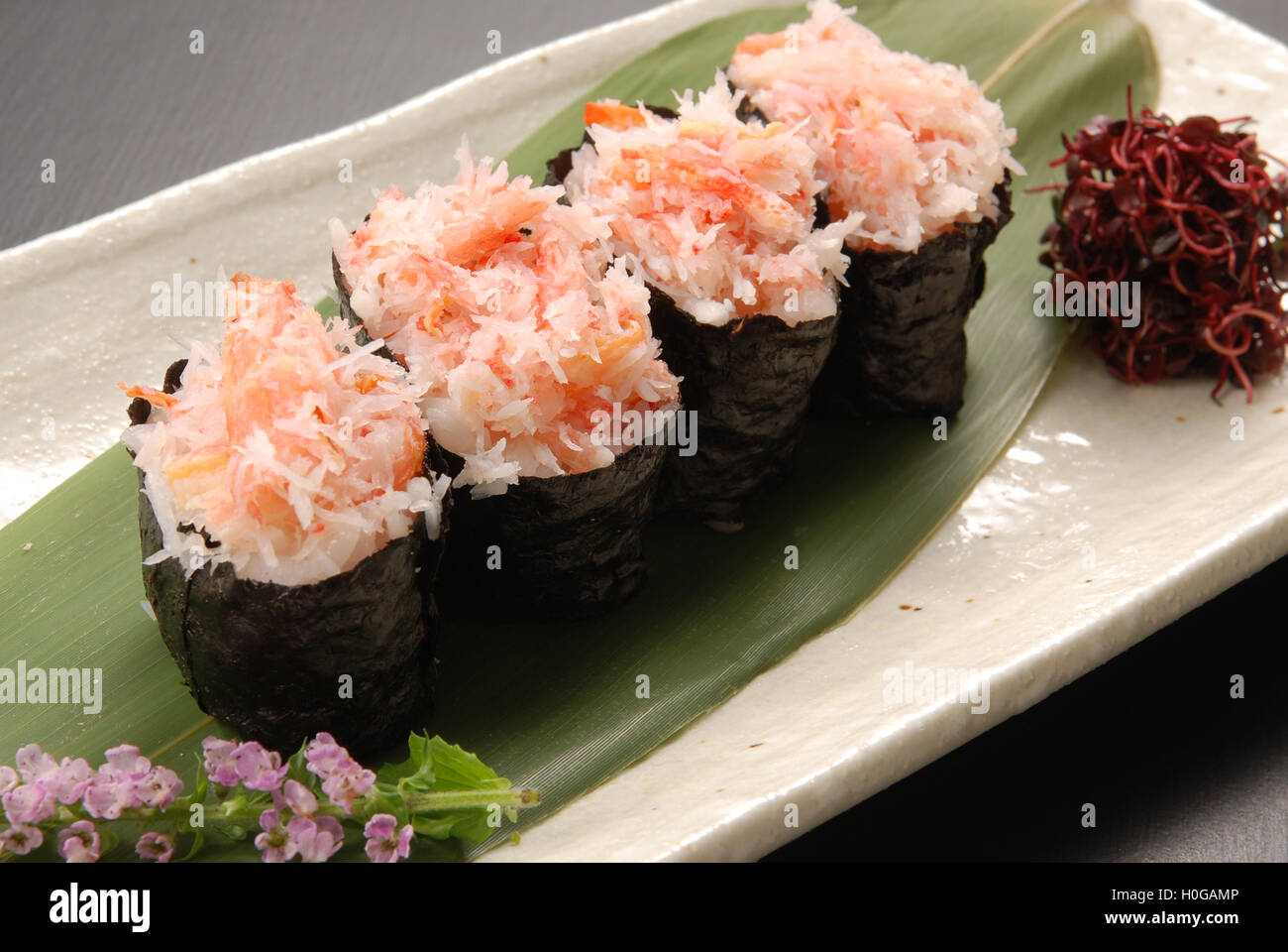 Red snow crab loosened kimbap on green leaf tray in restaurant Stock ...