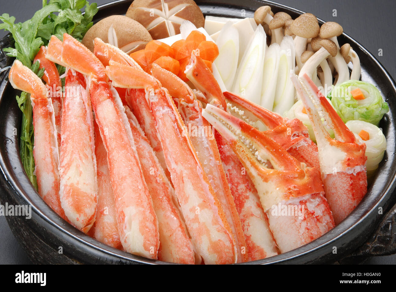 Raw fresh cold snow crab pot set with claws, legs, mushroom and onion ...