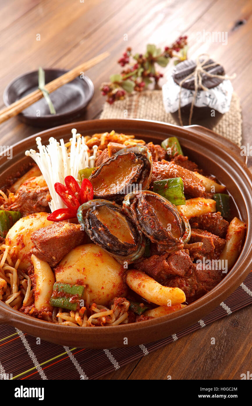 Big bowl of kimchi lunch with abalone, mushrooom, potatoes, beef and ...