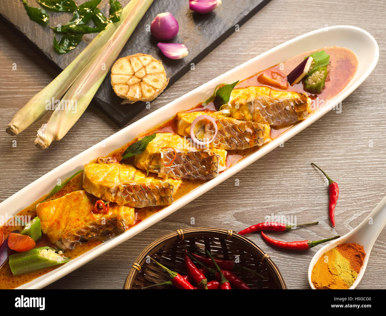 Asam Fish curry with garlic, chili, lemongrass, onion and sauce on ...