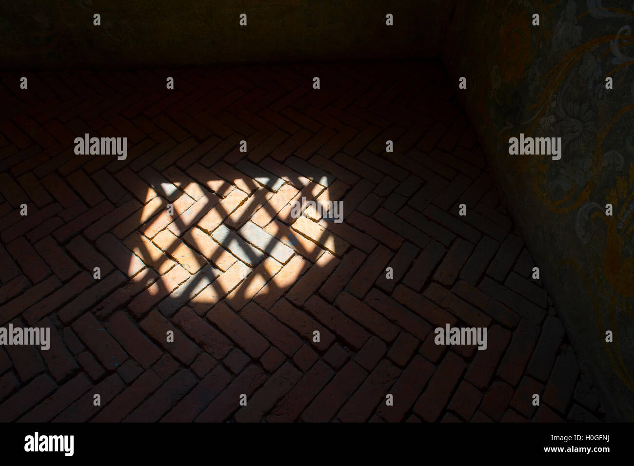 Window light on a brick floor Stock Photo - Alamy