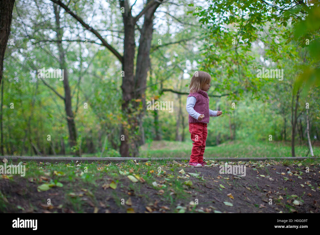 Little girl walking outdoor, having fun and laughting Stock Photo - Alamy