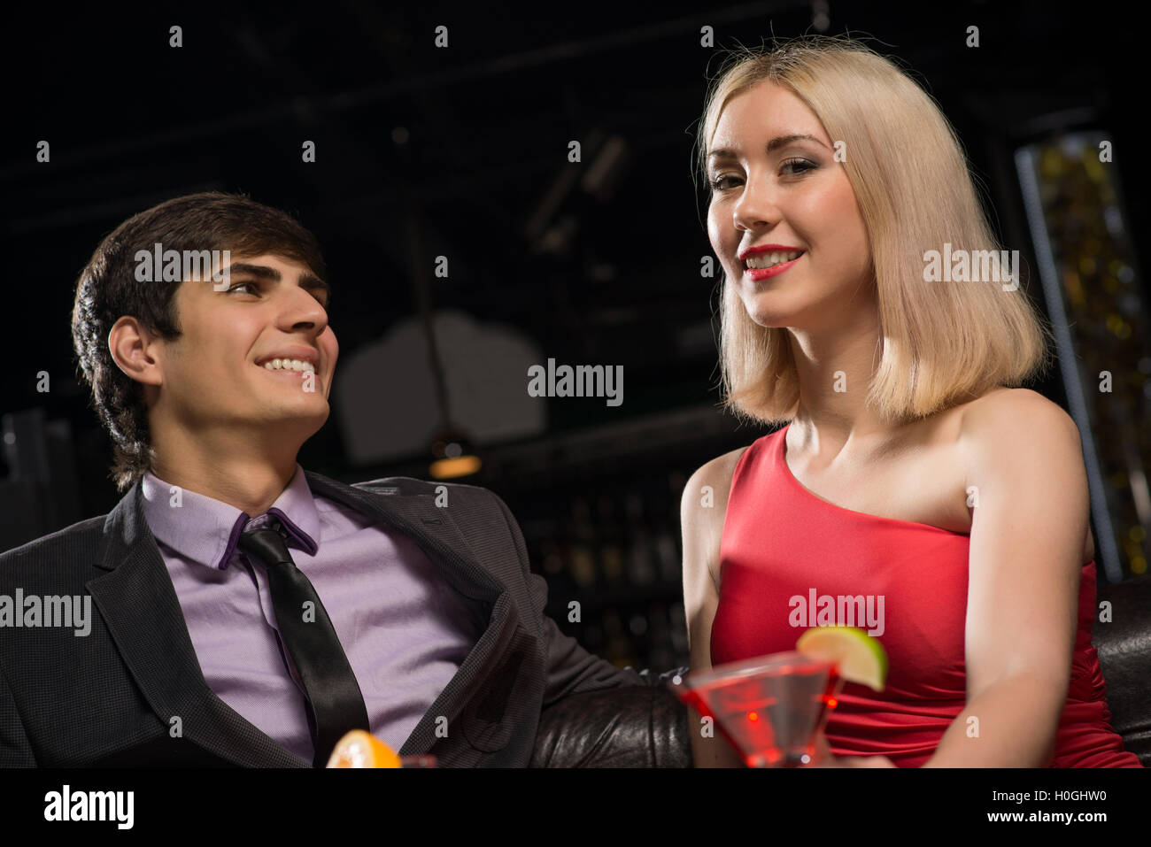 Young couple talking in a nightclub Stock Photo - Alamy