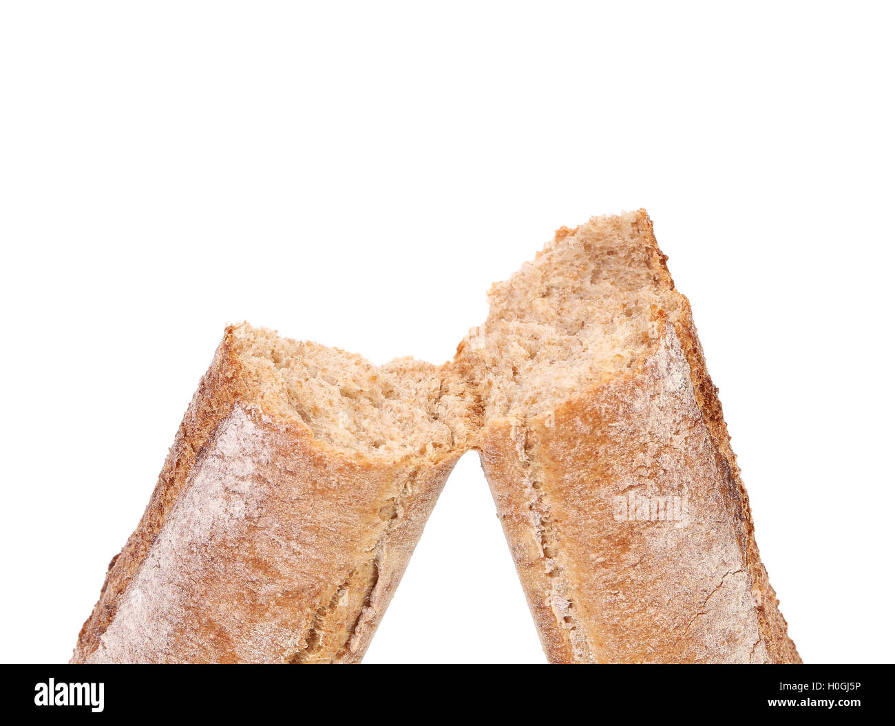 Broken long brown loaf Stock Photo - Alamy