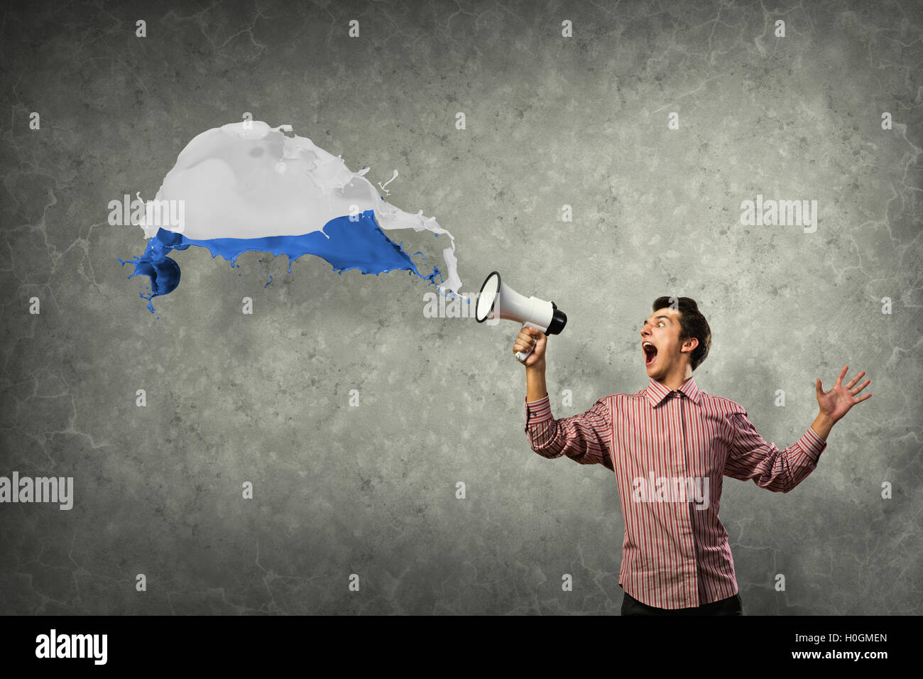 Portrait of a young man shouting using megaphone Stock Photo - Alamy