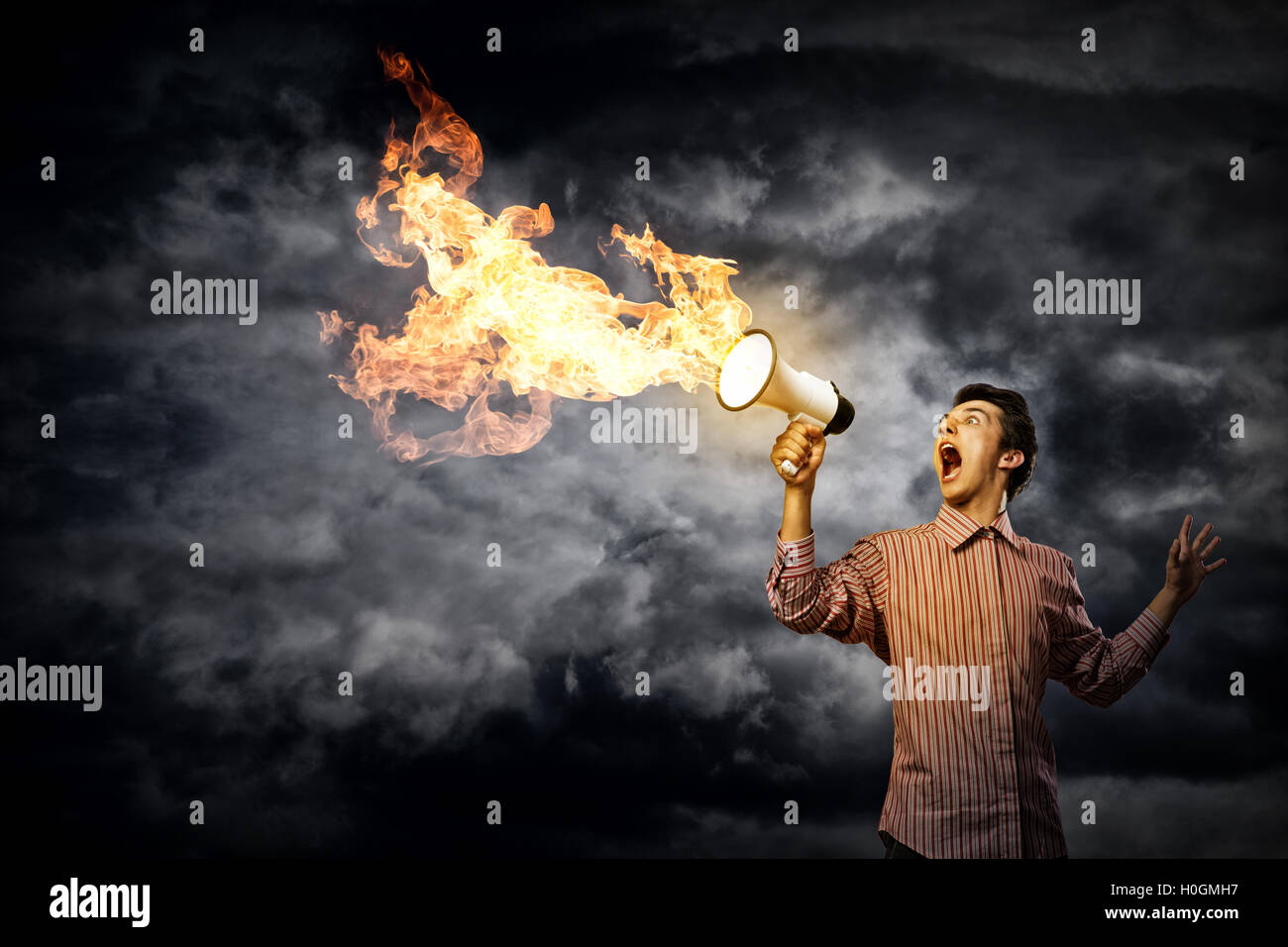 Portrait of a young man shouting using megaphone Stock Photo - Alamy