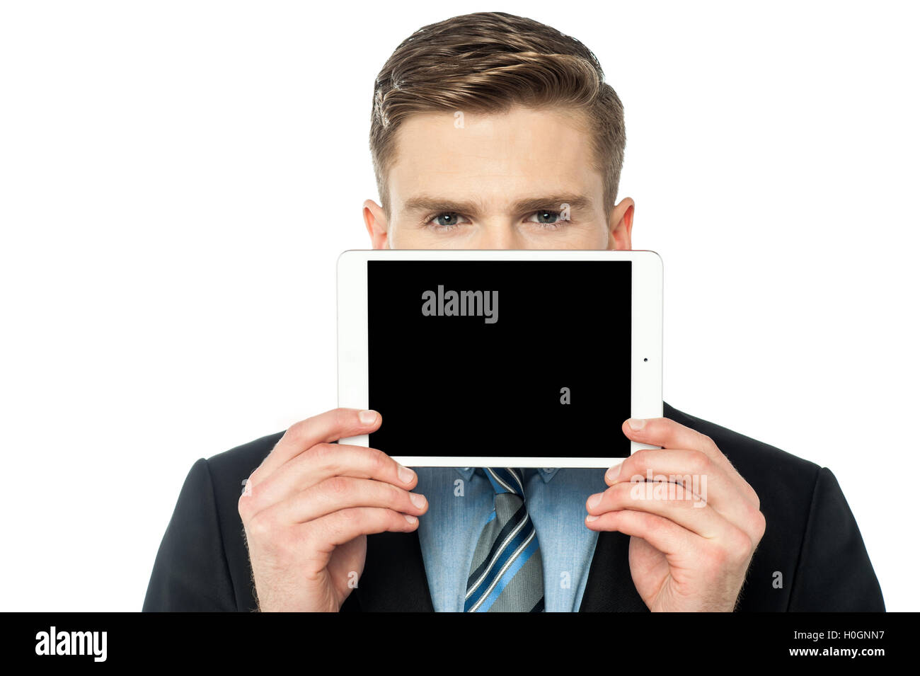 Man hiding his face with tablet device Stock Photo - Alamy