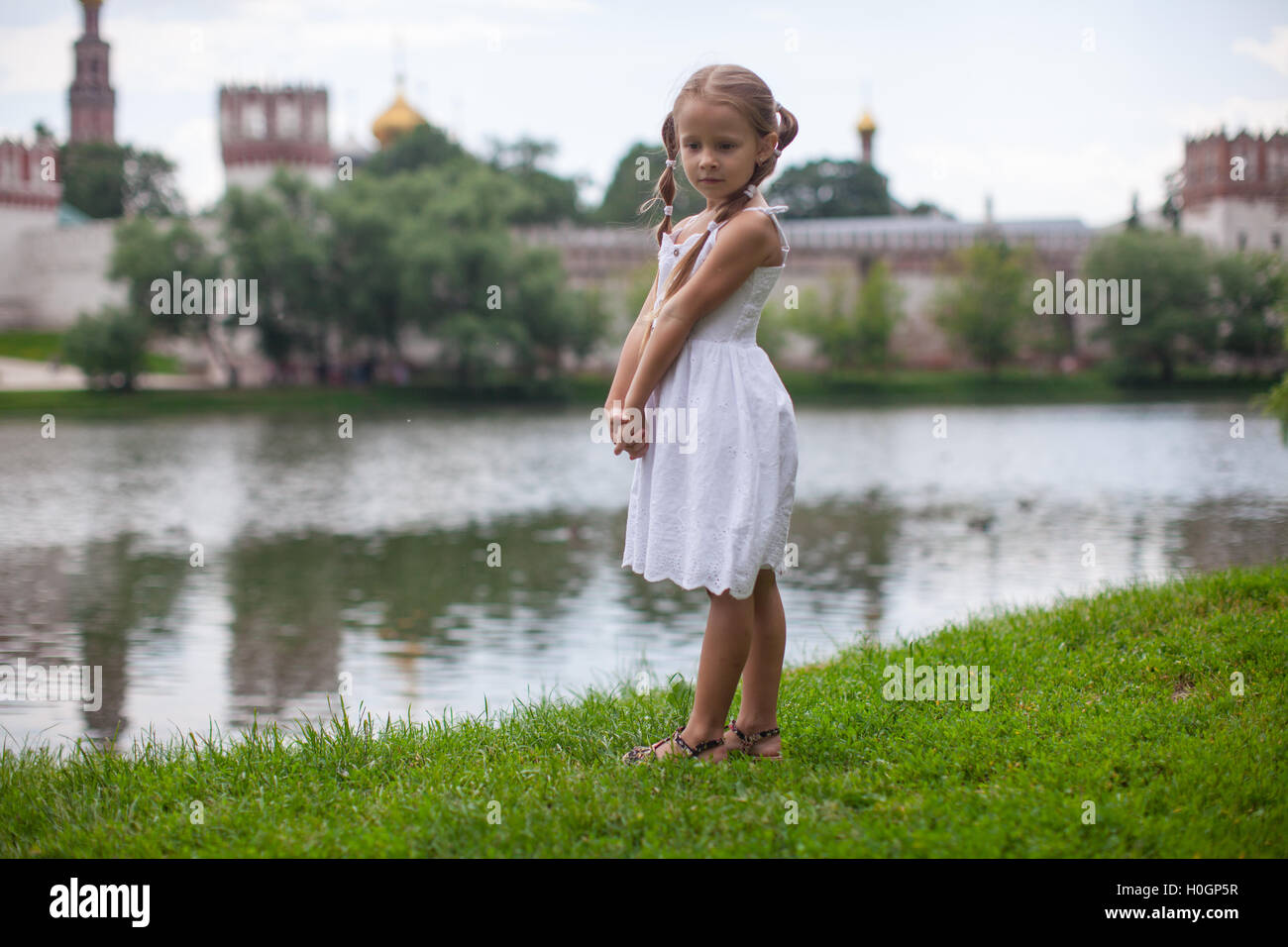 Little shy girl walking outdoor near the lake Stock Photo - Alamy