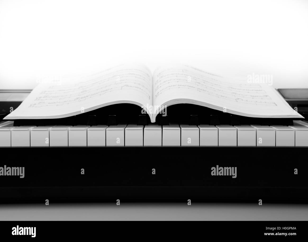 Piano keys and musical book Stock Photo - Alamy