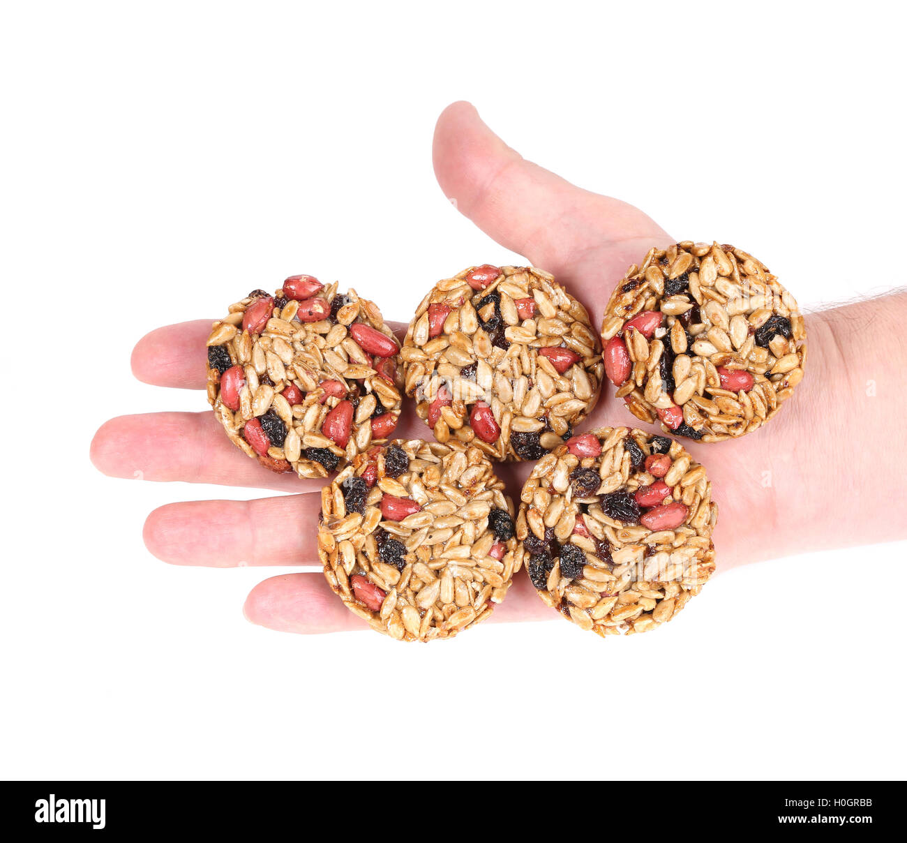 Round candied seeds and nuts in hand Stock Photo - Alamy