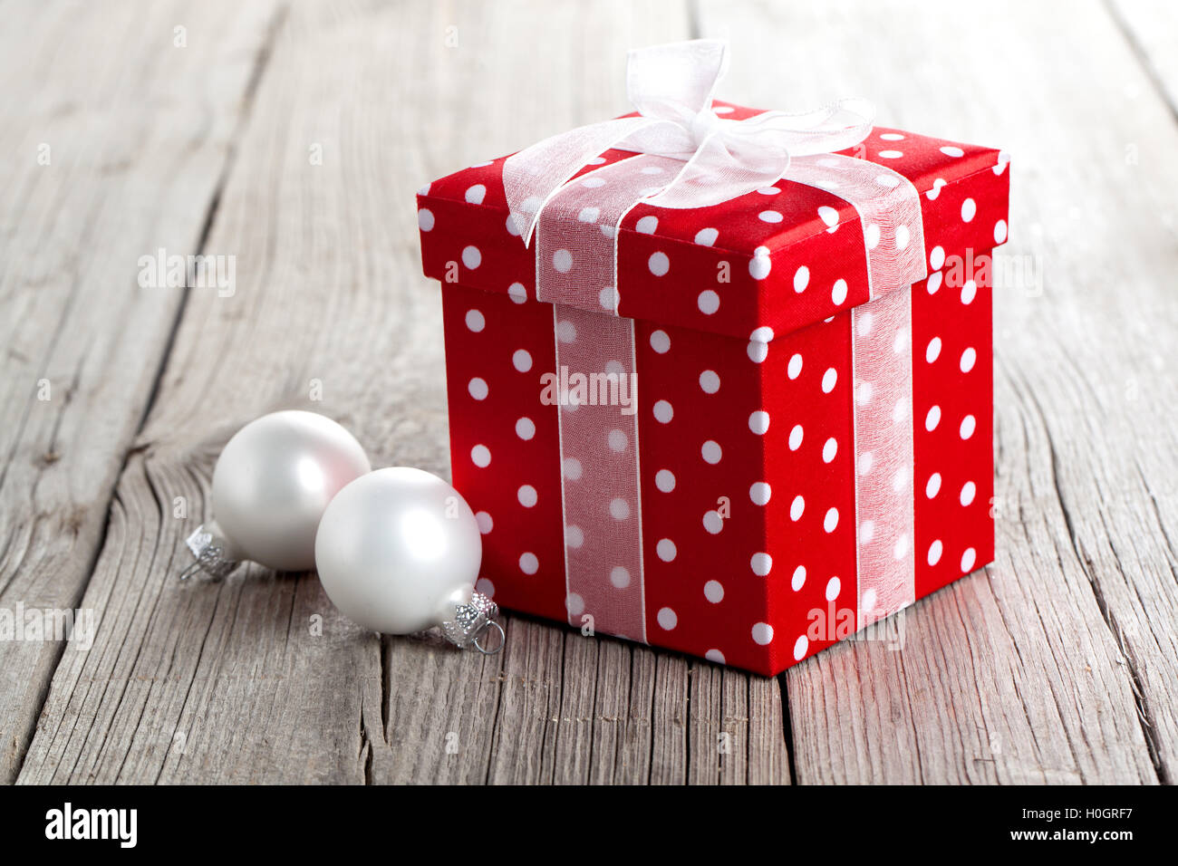 red gift box, polka dots, on wood background Stock Photo - Alamy