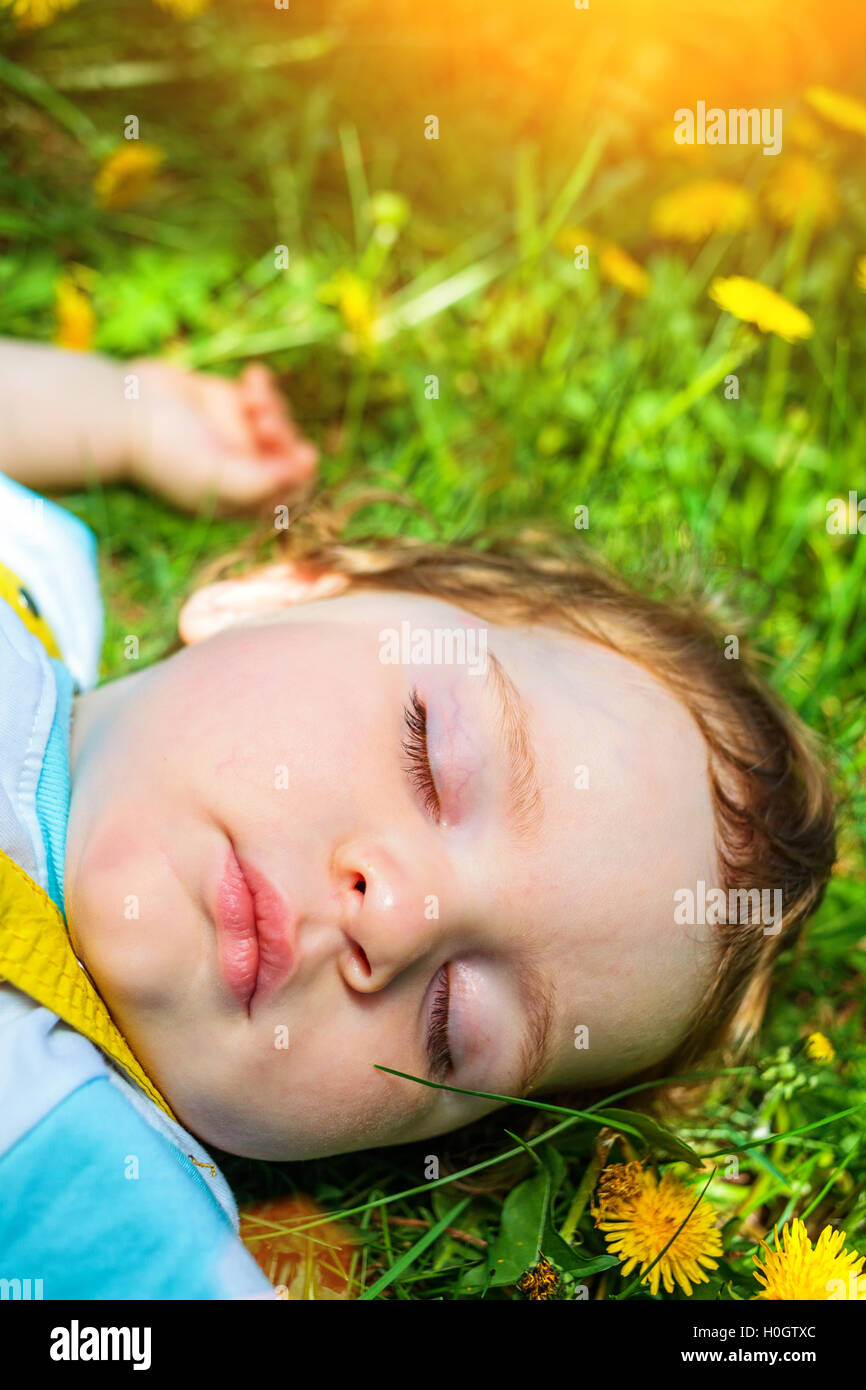 Boy sleeping laying on grass hi-res stock photography and images - Alamy