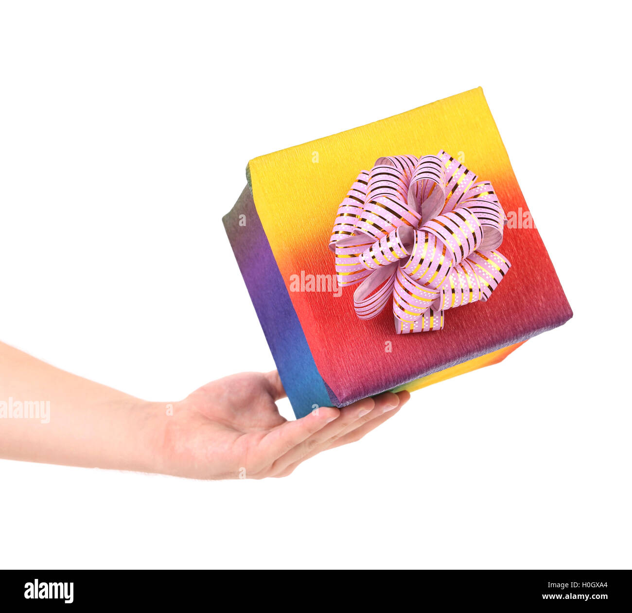 Hand holding gift in colorful package Stock Photo - Alamy