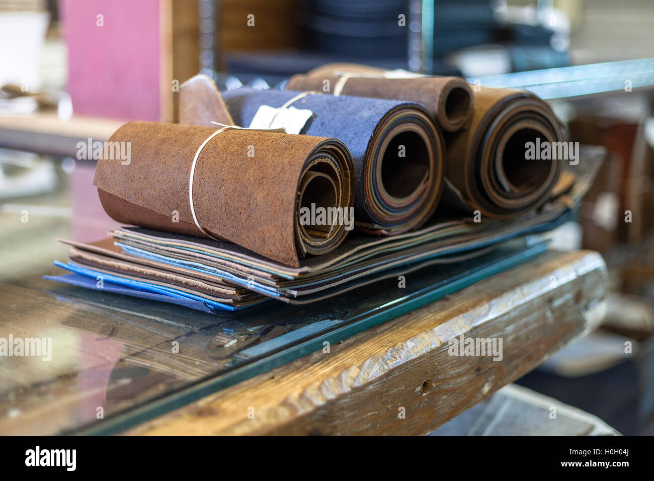 Bookbinder rolls of leather on workbench ready for use Stock Photo - Alamy