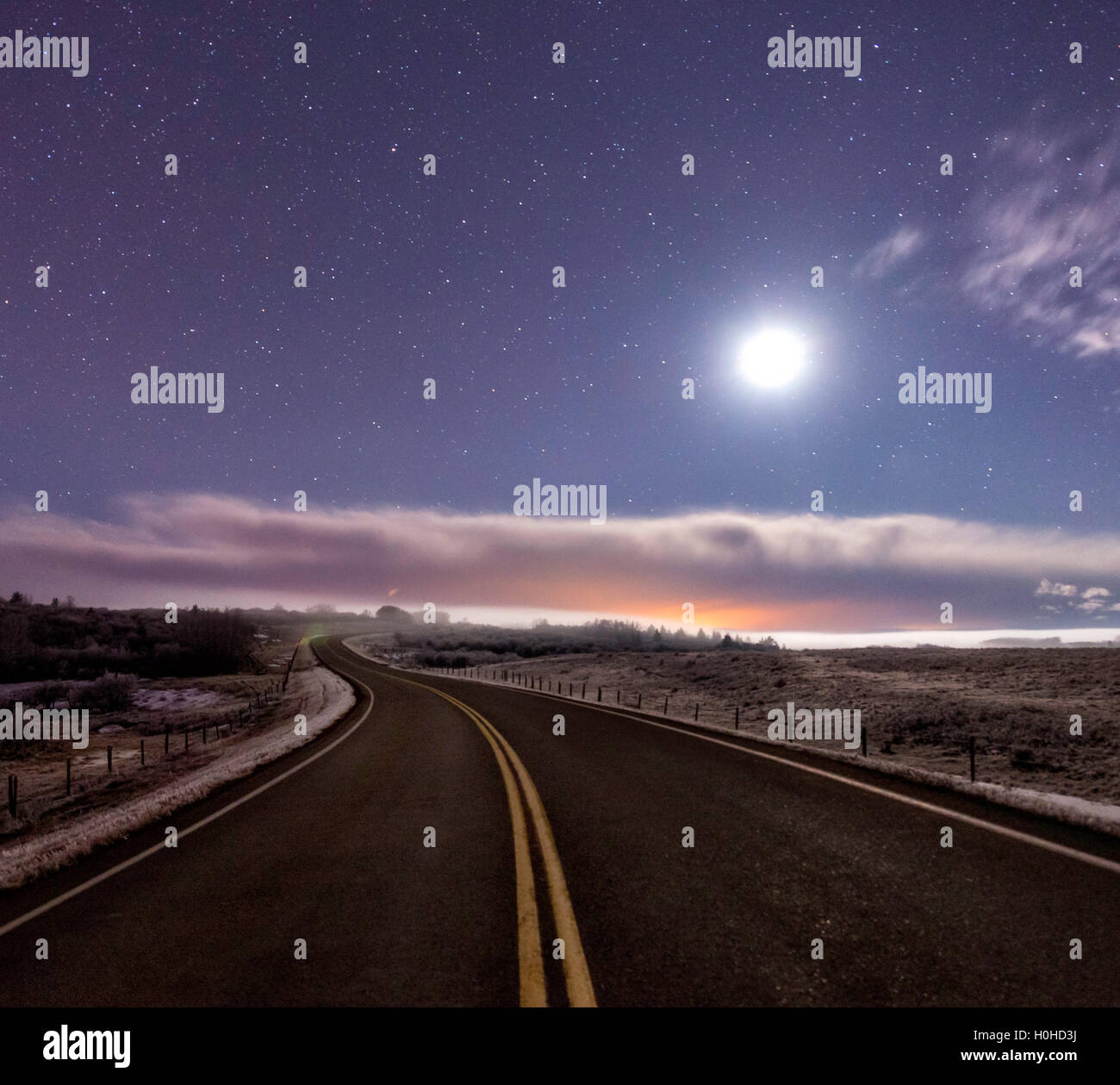 Curved road lit up by the moon Stock Photo - Alamy